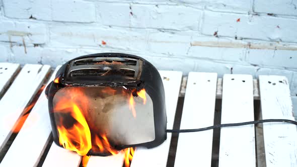 Burning Toaster. Toaster with Two Slices of Toast Caught on Fire Over ...
