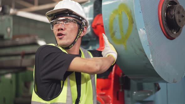 Asian male factory worker having accident arm stuck in the machine ...