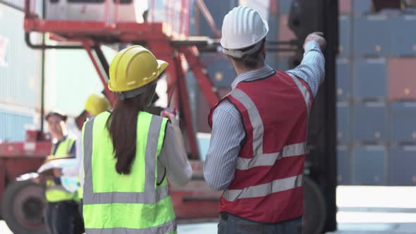 Dock worker team meeting in shipyard, Engineer and foreman in hardhat ...