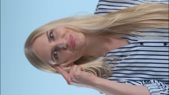 Attractive Woman Twisting Her Index Finger at Temple on Blue Background ...