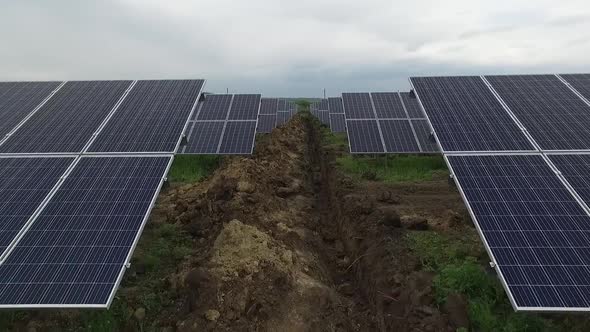 Flying Over the Solar Panels and a Trench with the Cables Construction ...