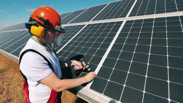 Solar Panel Technician Assembling a Solar Panel at a Solar Power ...