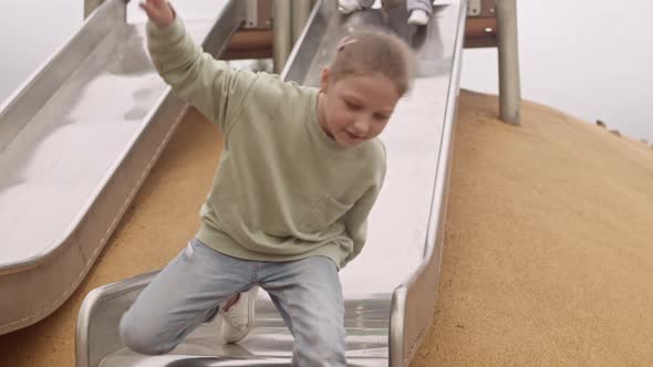 Diverse Kids Going Down Slide at Playground, Stock Footage | VideoHive
