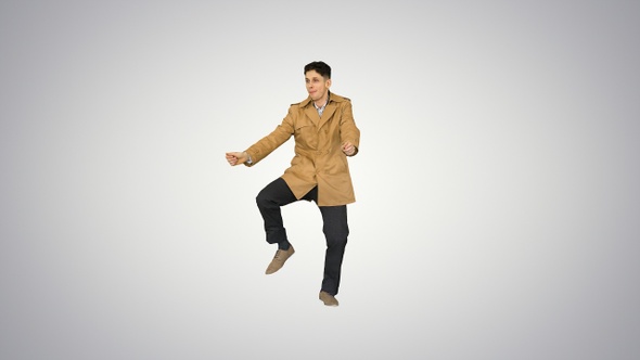 Young man wearing trench coat dancing and having fun on, Stock Footage