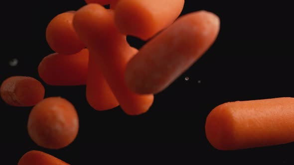 Camera follows throwing carrots into water. Slow Motion., Stock Footage