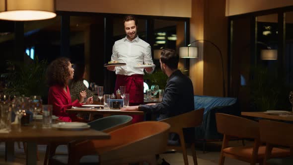 Waiter Serving Hungry Couple in Fancy Restaurant, Stock Footage | VideoHive