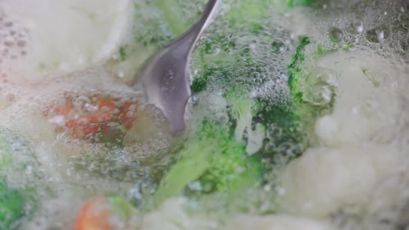 Stainless Steel Spoon Stirring and Removing Scum Foam Out From Boiling ...