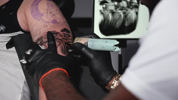 Cinematic Slow Motion Shot of a Tattoo Artist Creating Body Art at the ...