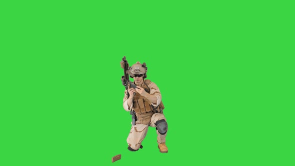 Soldier Shooting with Assault Rifle and Reloading on a Green Screen ...