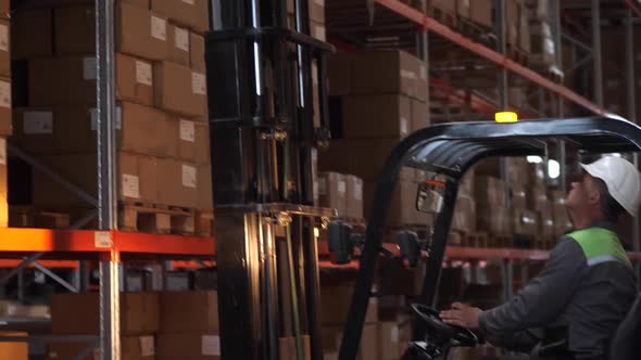 Warehouse Worker on Forklift Placing Load on Shelf, Stock Footage ...