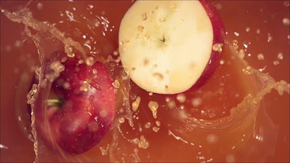 Red Apple Falling on Juice with Splash and Divided in Half, Stock Footage