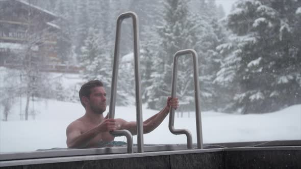 Close-up of a man stepping out of a pool at a luxury spa resort., Stock ...