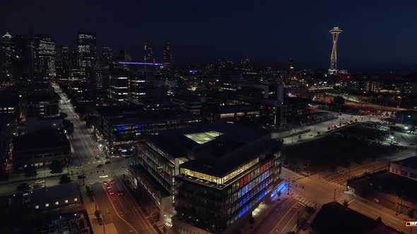 Aerial Of Downtown Seattle Lit At Night With Cars Driving On City ...