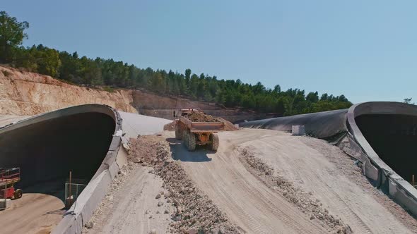 Aerial footage of large highway construction project with tunnels and ...