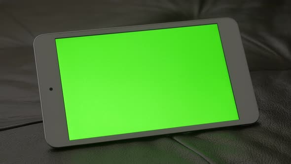 Green screen tablet PC on leather sofa 4K 2160p panning UHD footage ...