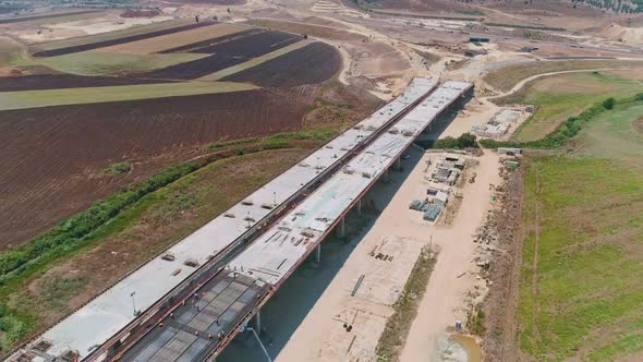 Aerial footage of large highway construction project with tunnels and ...