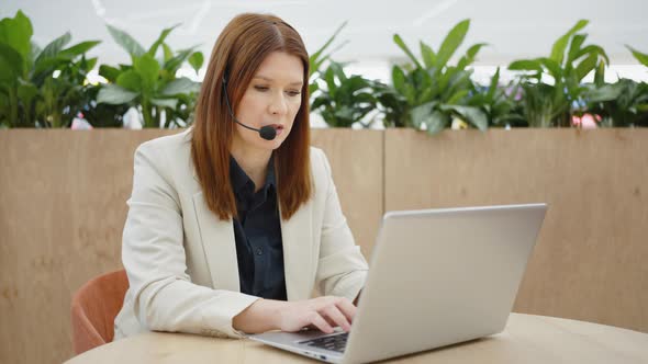Emergency Line Operator Using Headset and Laptop at Work, Stock Footage