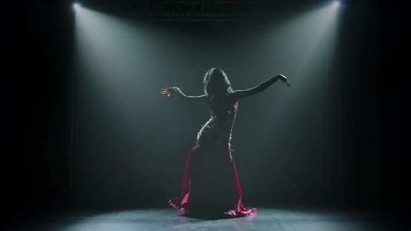Female Belly Dancer Shaking Her Hips. Shot in a Dark Studio with Smoke ...