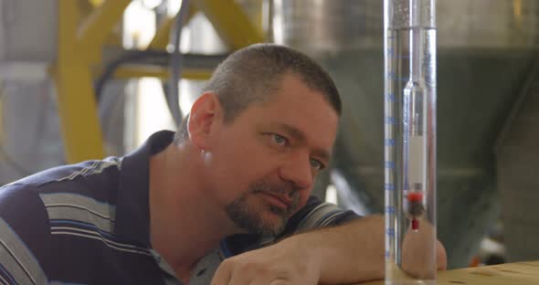 Male worker examining gin in measuring cylinder 4k, Stock Footage ...