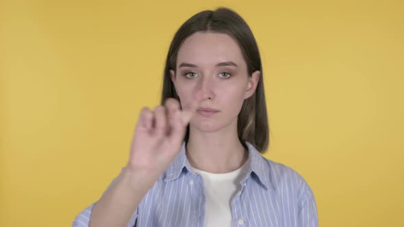 Young Woman Waving Finger To Refuse on Yellow Background, Stock Footage