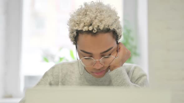 Close Up of African Woman Taking Nap While Using Laptop by Stockland