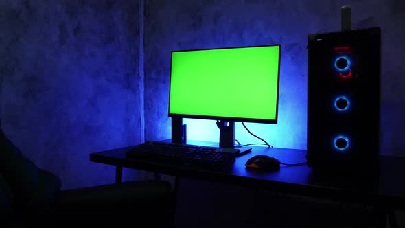 Blank green screen desktop computer on the table with RGB led lights in ...