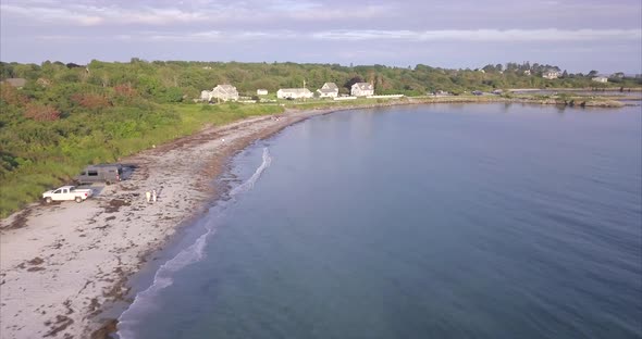 Aerial shot over Kettle Cove Beach on the Maine coast with white ...