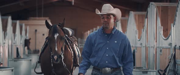 Cowboy walking with a horse, Stock Footage | VideoHive
