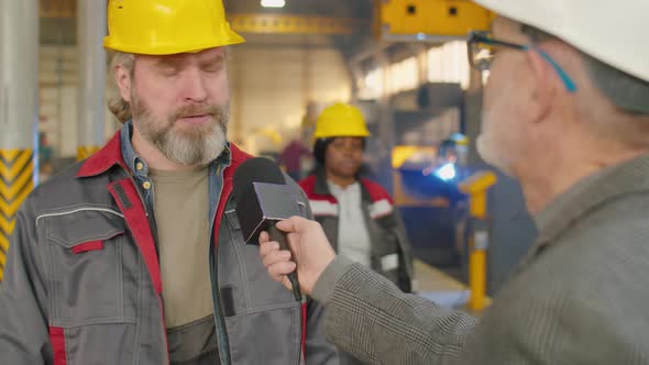 Factory Worker Giving Interview to TV Journalist, Stock Footage | VideoHive
