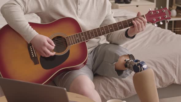 Talented Man with Prosthetic Leg Playing Acoustic Guitar, Stock Footage