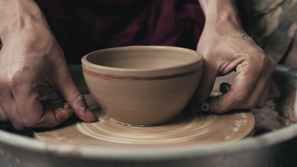 Potter Shapes the Clay Product with Pottery Tools on the Potter's Wheel ...