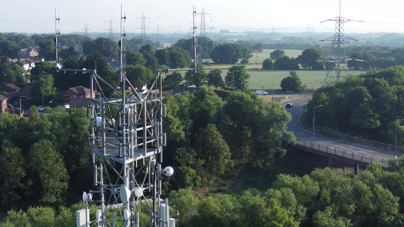 5G signal tower antenna in British countryside with vehicles travelling ...