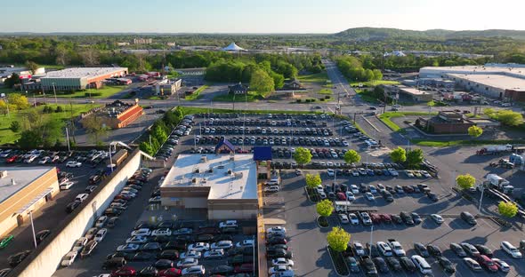 Aerial descending shot of full parking lot. Cars parked at CarMax ...