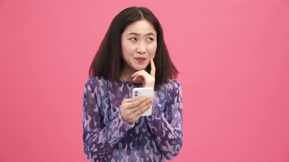 Positive Asian woman texting on phone, Stock Footage | VideoHive