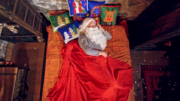 Santa Claus is sleeping in specially decorated room in his bed, Stock ...