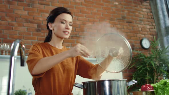 Woman Cooking Healthy Food in Kitchen. Girl Salting Hot Meal in Boiling ...