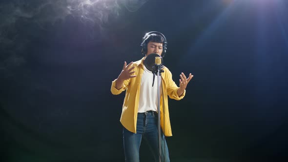 Asian Boy With Headphone Rapping Into A Condenser Microphone On The ...
