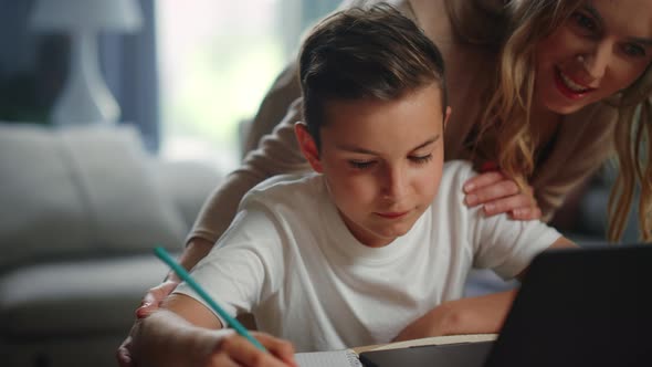 Mom Helping Son Doing Homework. Mother Cheering Up Kid During Distance ...