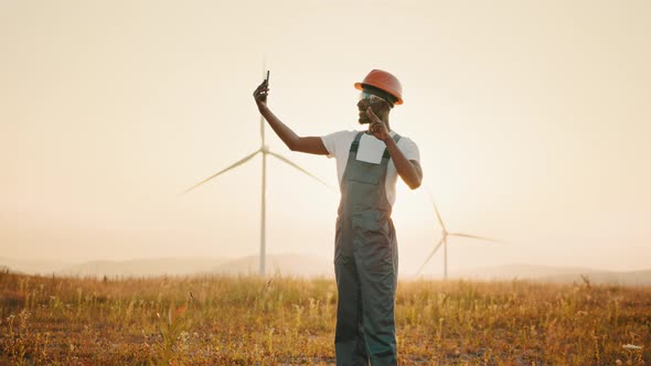 Positive Engineer in Uniform and Helmet Using Modern Smartphone for ...