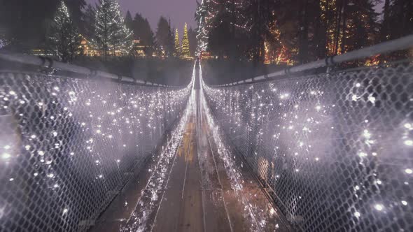 Long Suspension bridge decorated with Christmas lights, Rainy night ...