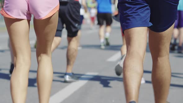 Buttocks of Man and Woman Running Marathon in Slow Motion, Stock Footage