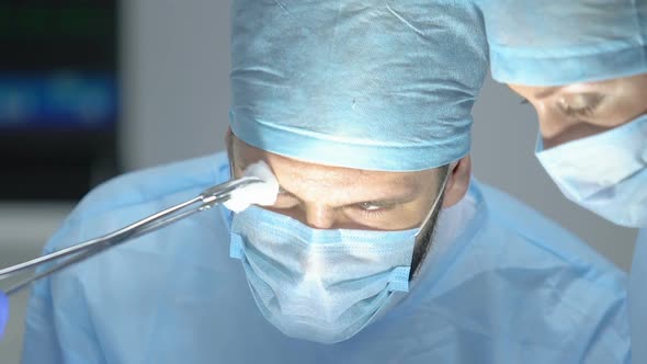 Nurse Wiping Sweat on Doctor Forehead by Cotton, Difficult Operation ...