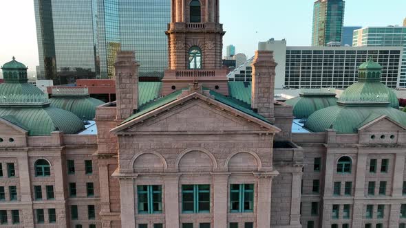 Aerial rising shot of downtown courthouse. Large clock spire at the ...