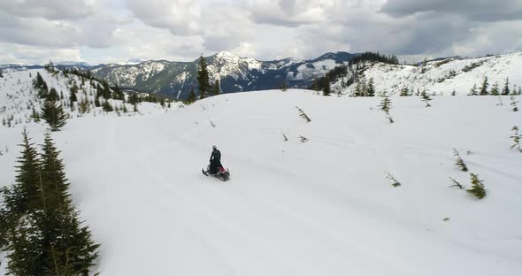 Snowmobile Winter Man Riding Snowmachine Down Mountain Cattrack Aerial ...