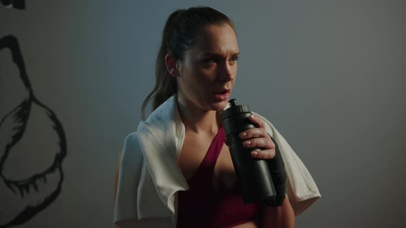 A Young Athletic Woman Drinks Water From a Bottle After Boxing Training ...