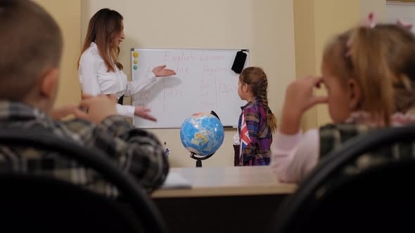 Closeup of Teacher Working with Children in a Classroom in an ...