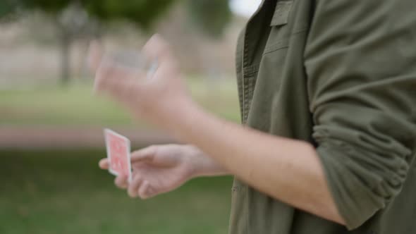 Close Up Shot of the Hands of a Male Street Magician Playing with Cards ...