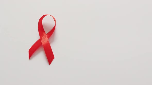 Video of red blood cancer ribbon on white background, Stock Footage