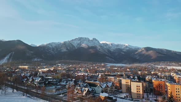 Zakopane city with mountains in background, Poland. Aerial backward ...