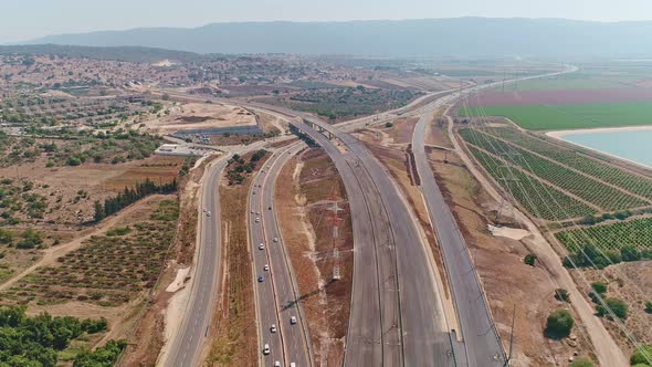 Aerial footage of large highway construction project with tunnels and ...
